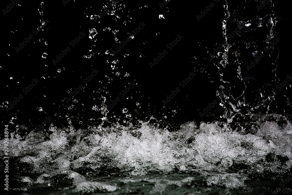 Movement of the Water splash on black background. Water drop from the ...