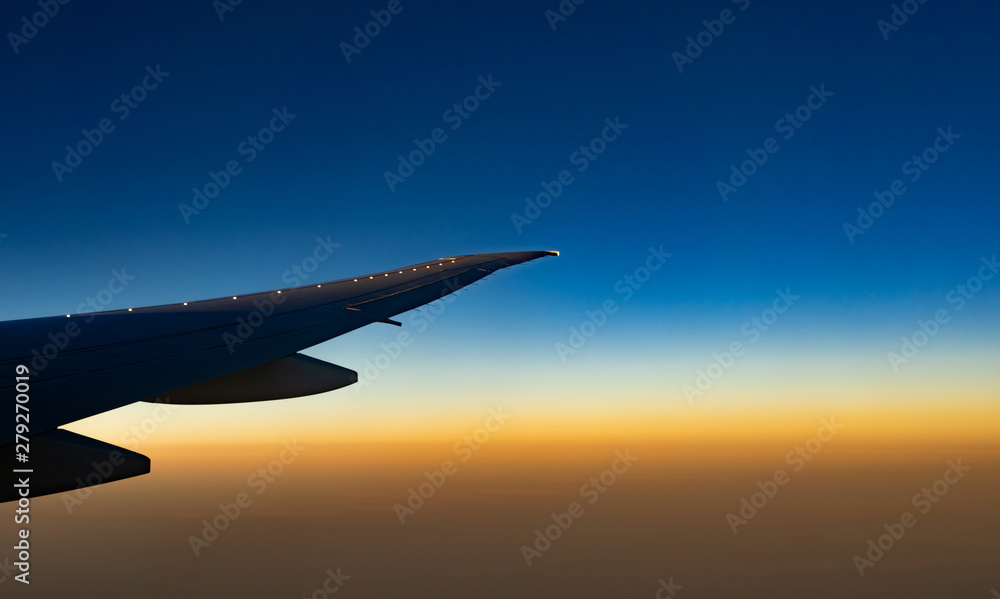 Wing of plane over the city. Airplane flying on blue sky. Scenic view ...