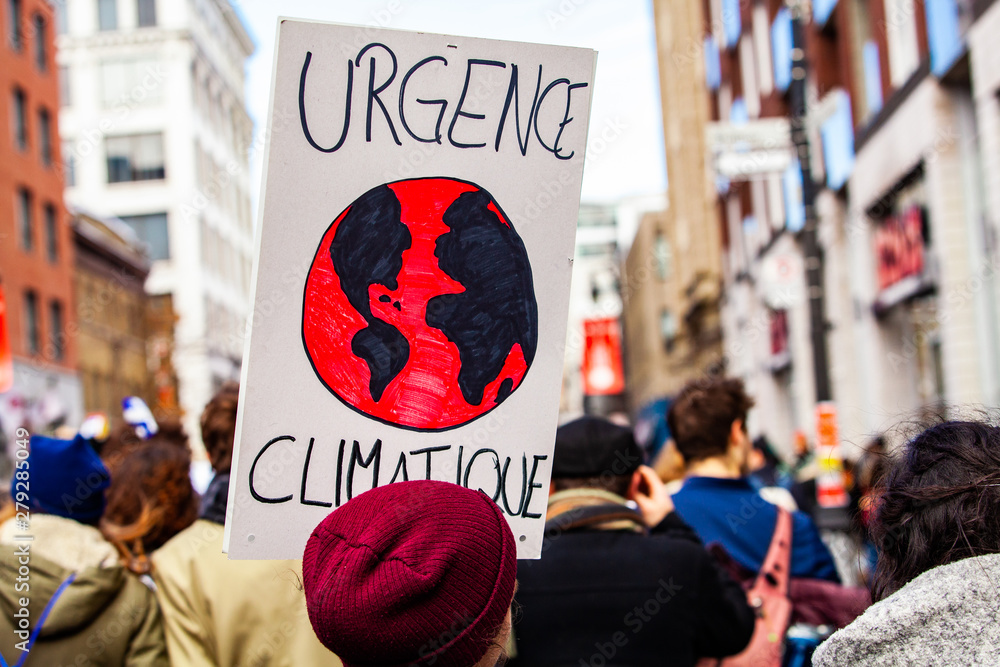 Eco protestor holds French sign. A close up view of a French sign held ...