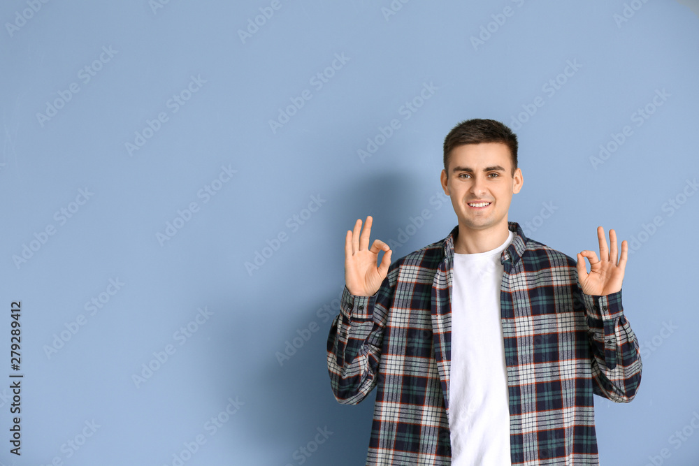 Young deaf mute man using sign language on grey background Stock 写真 ...