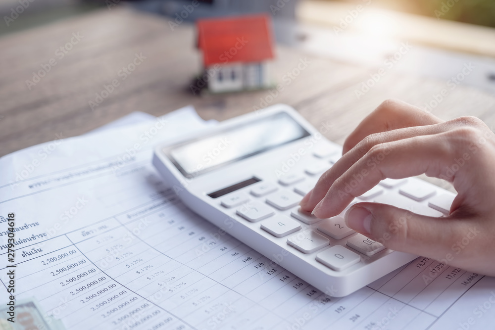 Customers use pens and calculators to calculate home purchase loans ...
