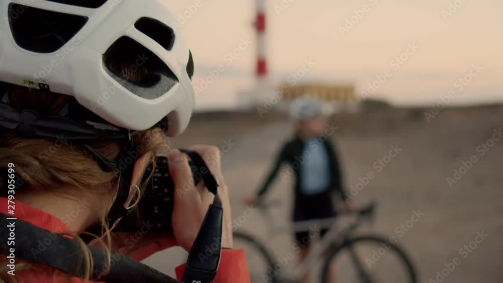 Two best friends, female cyclists on road bikes make photos of each ...