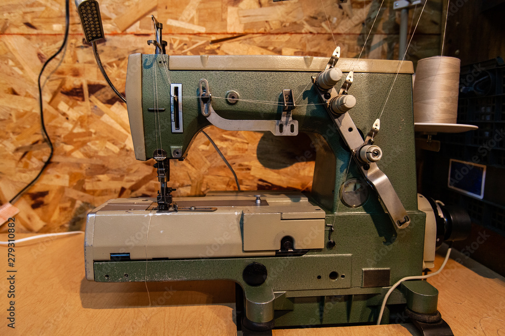 Vintage industrial sewing machine. A closeup and side profile view of a ...