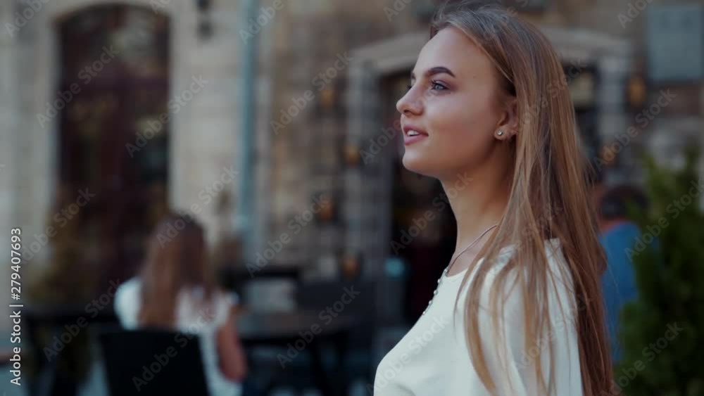 Confident young stylish fancy woman walking down the city, excitedly ...