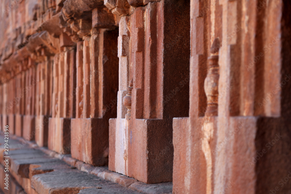 Row of historic pillars built with red rocks in Badami city , Karnataka ...