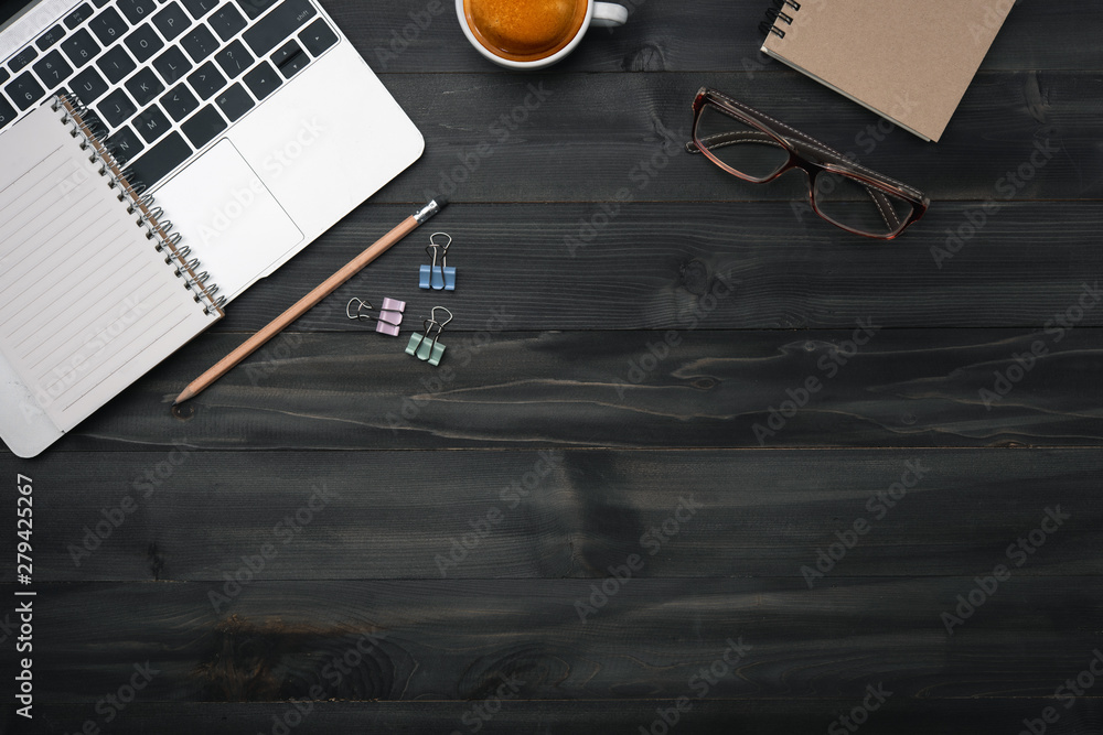 Modern dark wood office desk table with laptop, smartphone and other ...