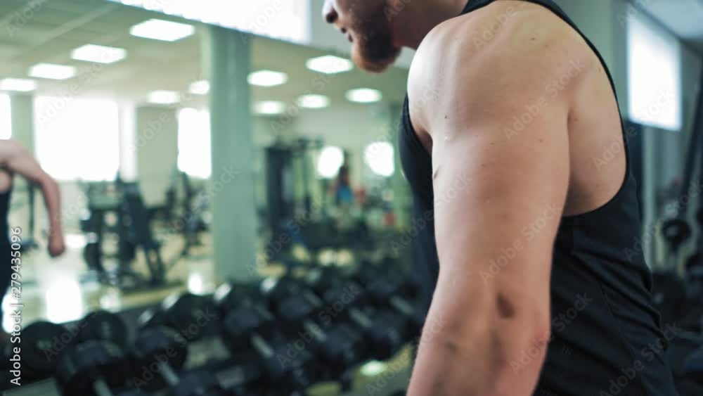 Vidéo Stock Strong athletic man on mirror background in gym. Muscular ...
