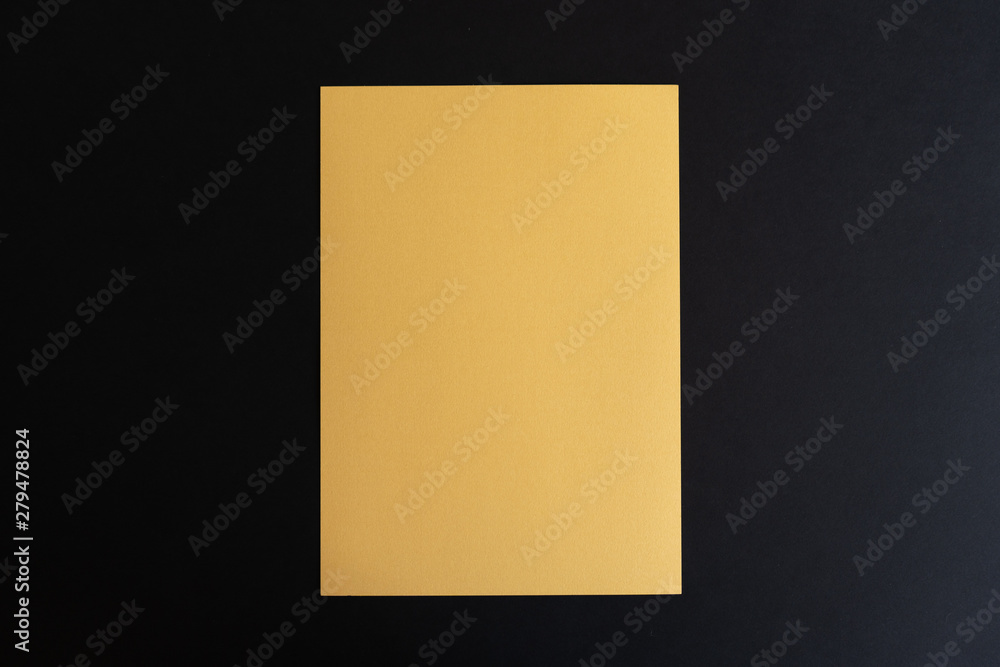 Blank gold paper sheet on black background. Layout for business ...