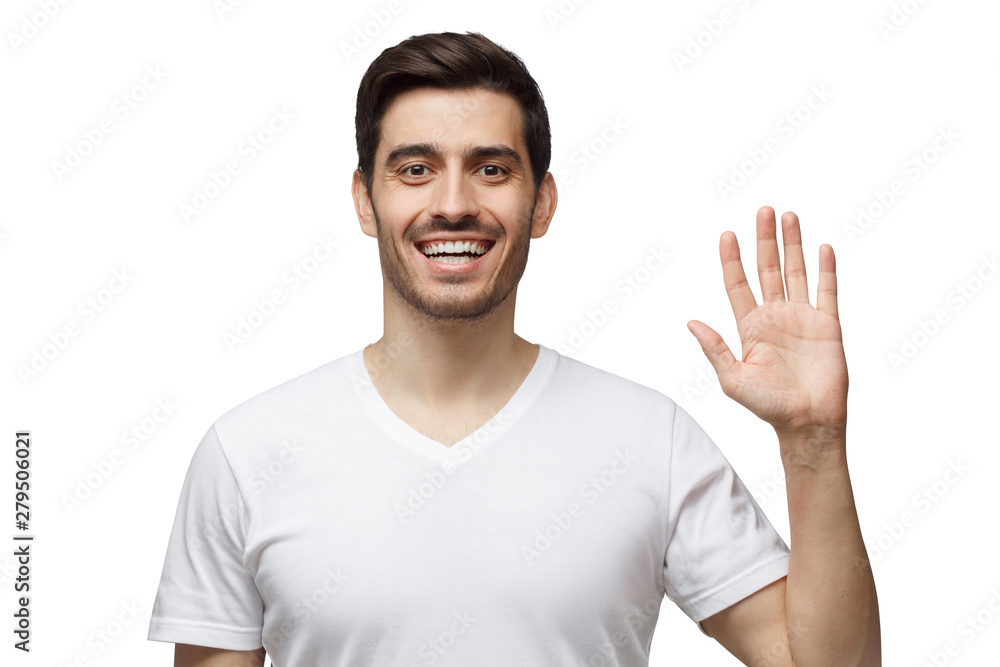 Hello! Hi! Young man greeting you with open hand, smiling, enjoying ...