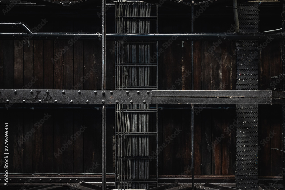 Industrial exposed ceiling with timber boards, steel beams and exposed ...
