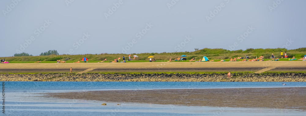 People recreating naked at the nudist beach of Tholen, Bergse diepsluis ...