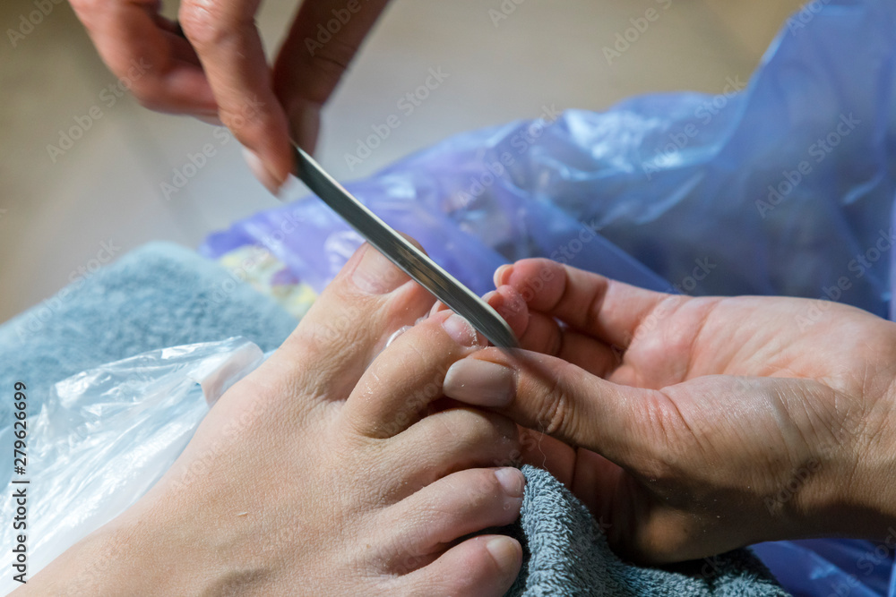 Process of pedicure at beauty salon. Manicurist work on a woman client ...
