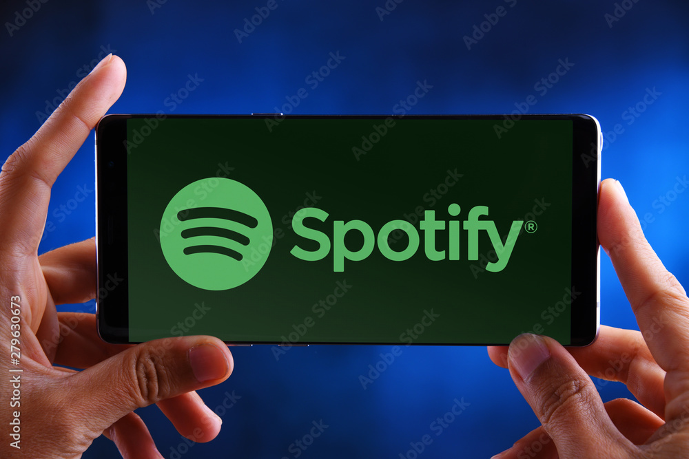 Hands holding smartphone displaying logo of Spotify Stock Photo | Adobe ...