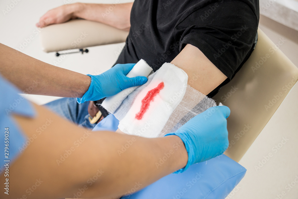 Nurse dressing wound for patient's hand with deep skin cutting. Stock ...