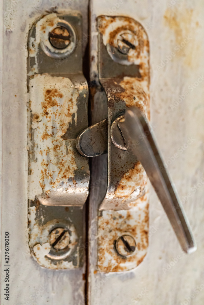 Old metal lock on a white wooden window frame. Old wooden window frame ...