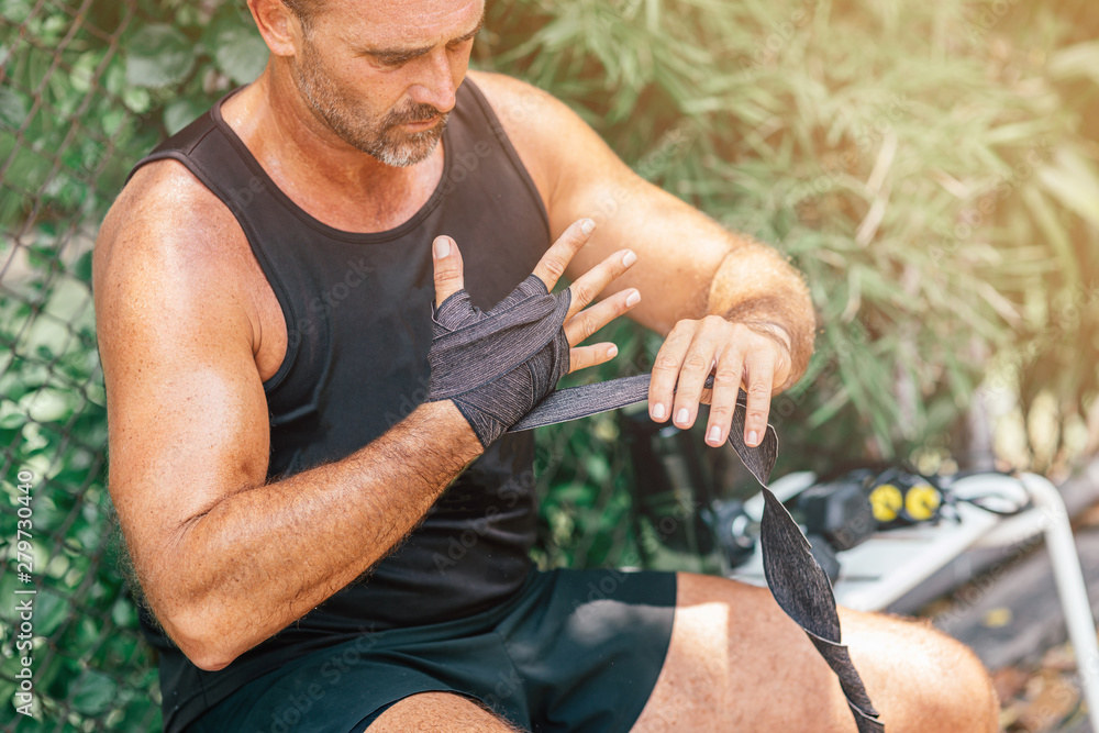 The master of body transformation. Muscular man in black sportswear ...