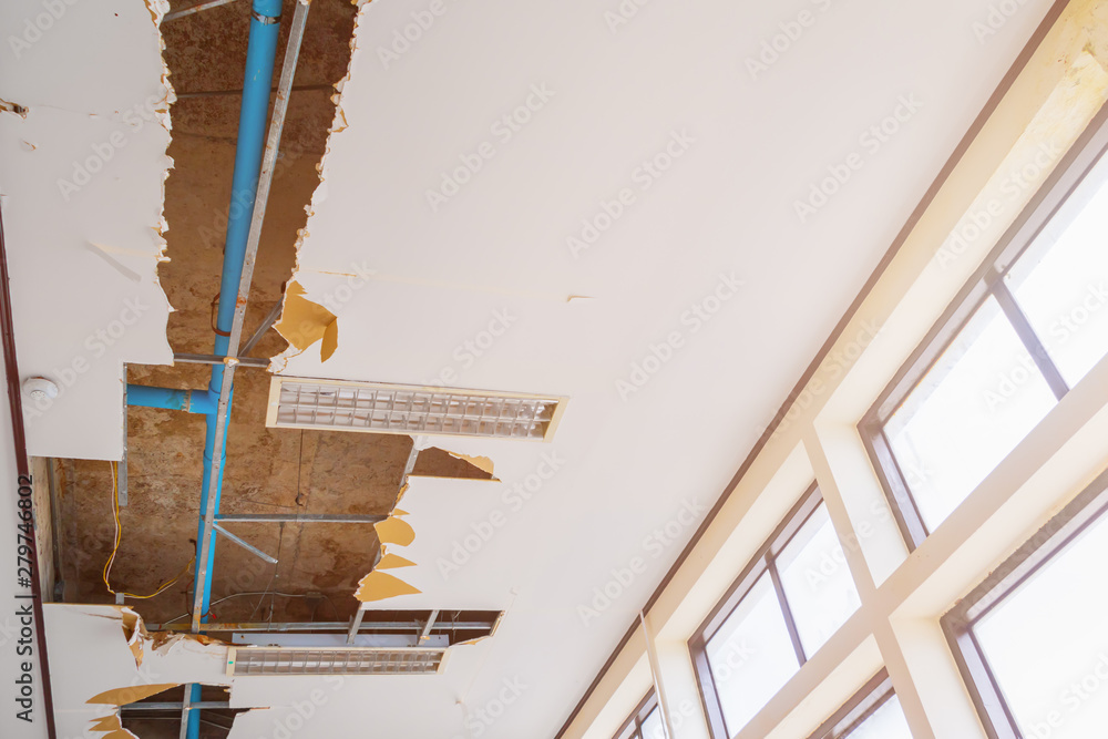 repair leak water pipe on gypsum ceiling interior office building Stock ...