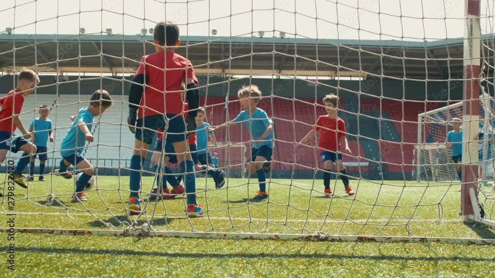 Boys playing soccer, getting long pass, attacking goal post and making ...