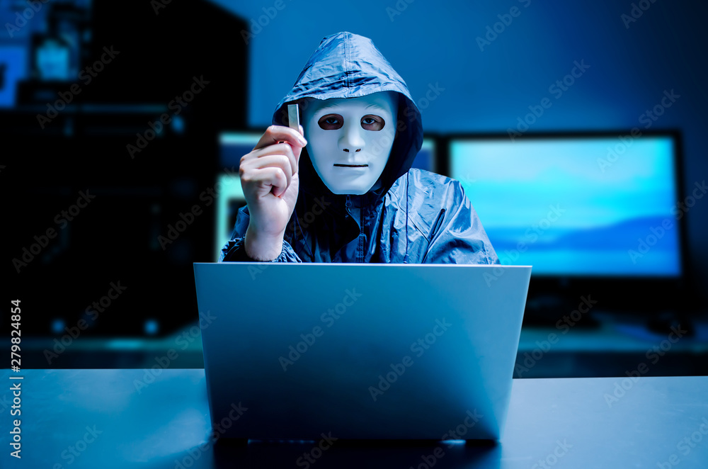 Anonymous computer hacker in white mask and hoodie. Obscured dark face ...