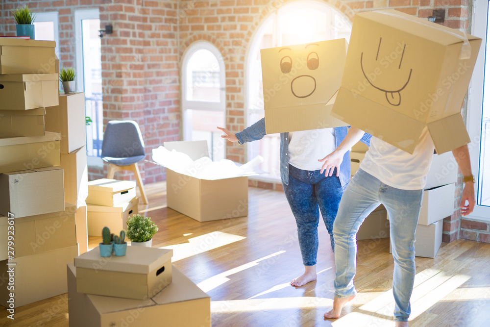 Crazy couple wearing cardboard boxes with funny emoji faces over head ...