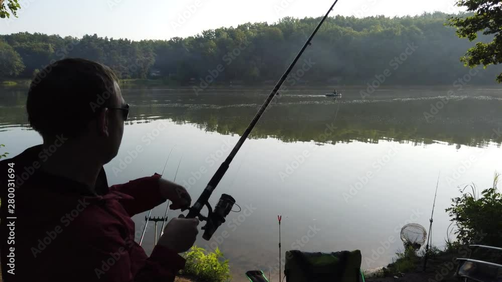 Vidéo Stock Fishing on the forest lake. A man was fishing on a spinning ...