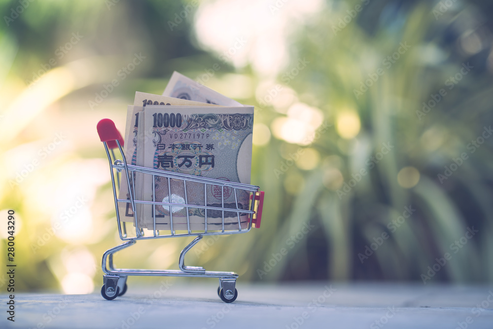 Model shopping cart with 10000 JYP Japanese yen banknote Stock Photo ...