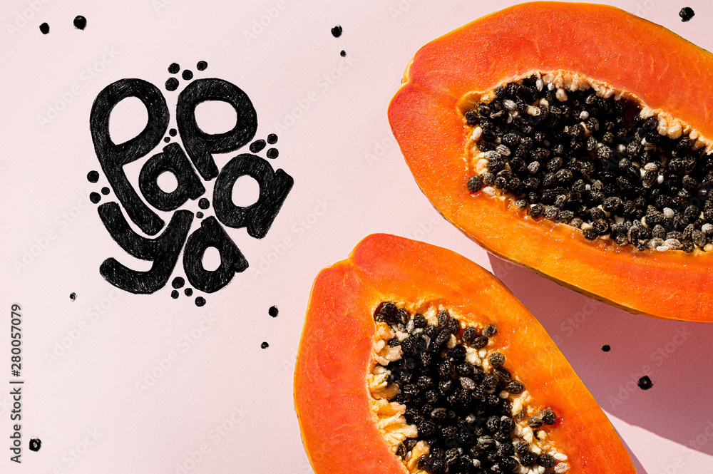 Flat lay of papaya exotic tropical fruit and hand lettering with pencil ...