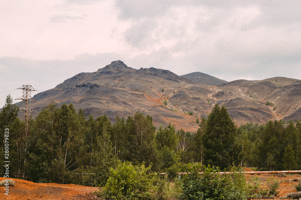 Foto de landscape with landscape with bald mountains polluted copper ...