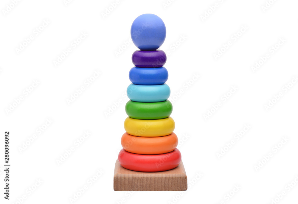 Toy pyramid from rainbow colored wooden rings with a ball head on top ...
