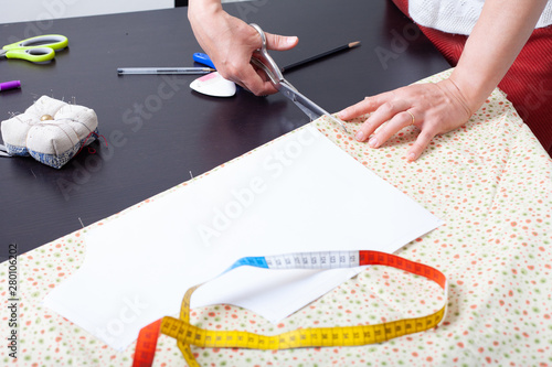 Dressmaker at work, building patterns, hands, modeling, measuring ...