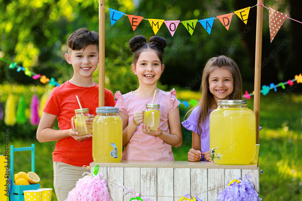 Cute little children at lemonade stand in park. Summer refreshing ...