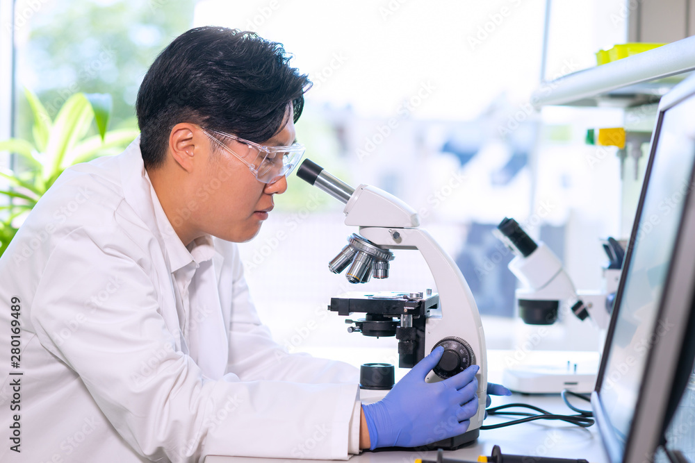 Scientist working in lab. Asian doctor making medical research ...