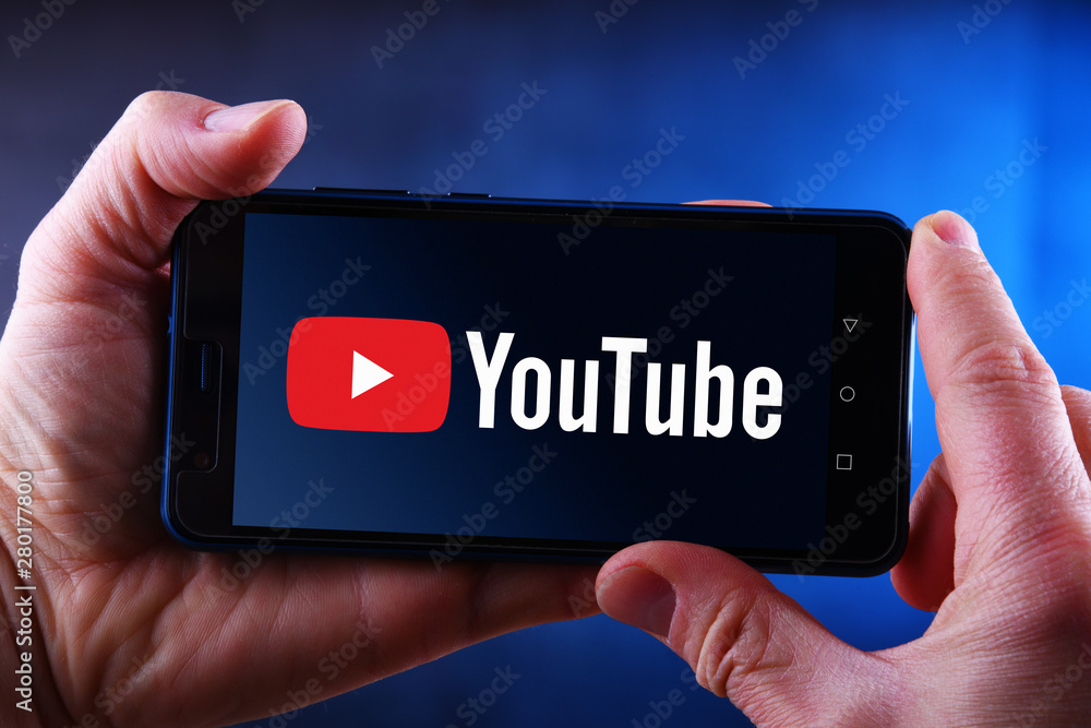 Hands holding smartphone displaying logo of YouTube Stock Photo | Adobe ...