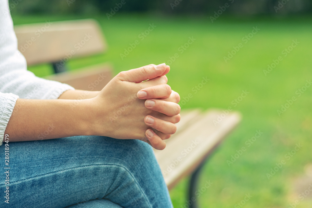 Christian worship and praise. A young woman is sitting and praying on a ...