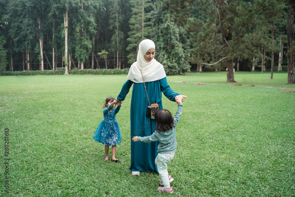 Muslim families enjoy holidays together, two little girls with their ...