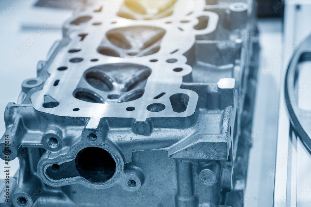 The aluminium cylinder head of the engine in the light blue scene. The ...