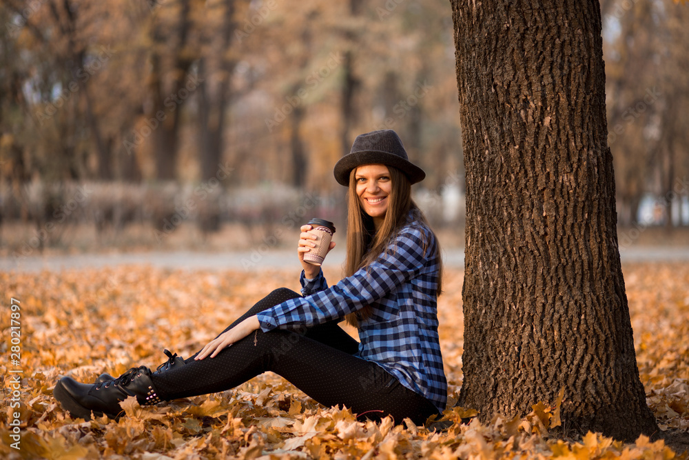 Fall concept. Happy and cheerful woman in hat, drinking coffee while ...