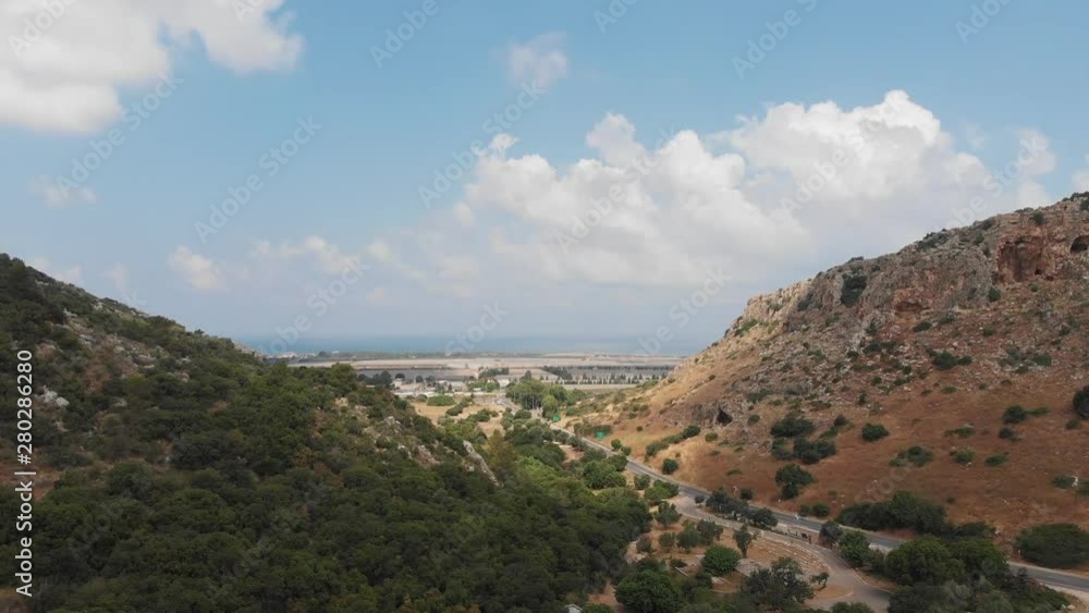The slopes of Mount Carmel with rich vegetation and caves. View from ...