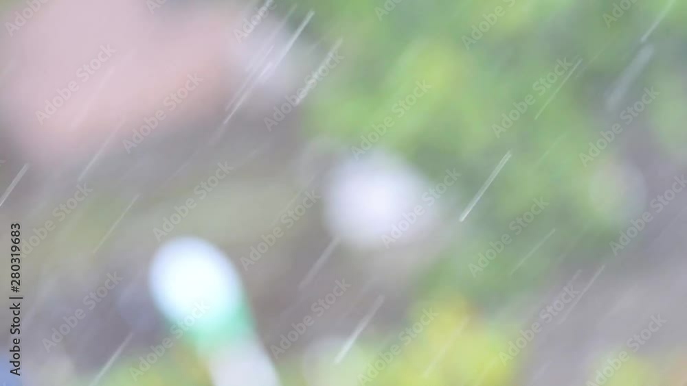 Rain water drops falling in air with blur building background, slow ...