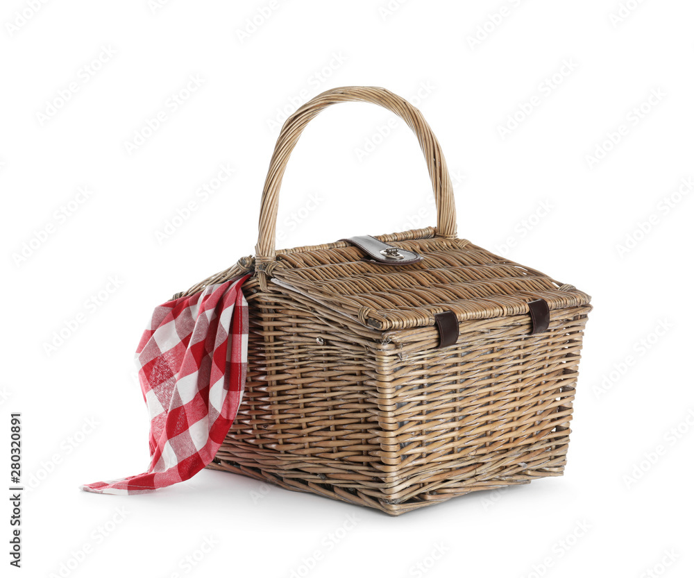 Closed wicker picnic basket with checkered blanket on white background ...