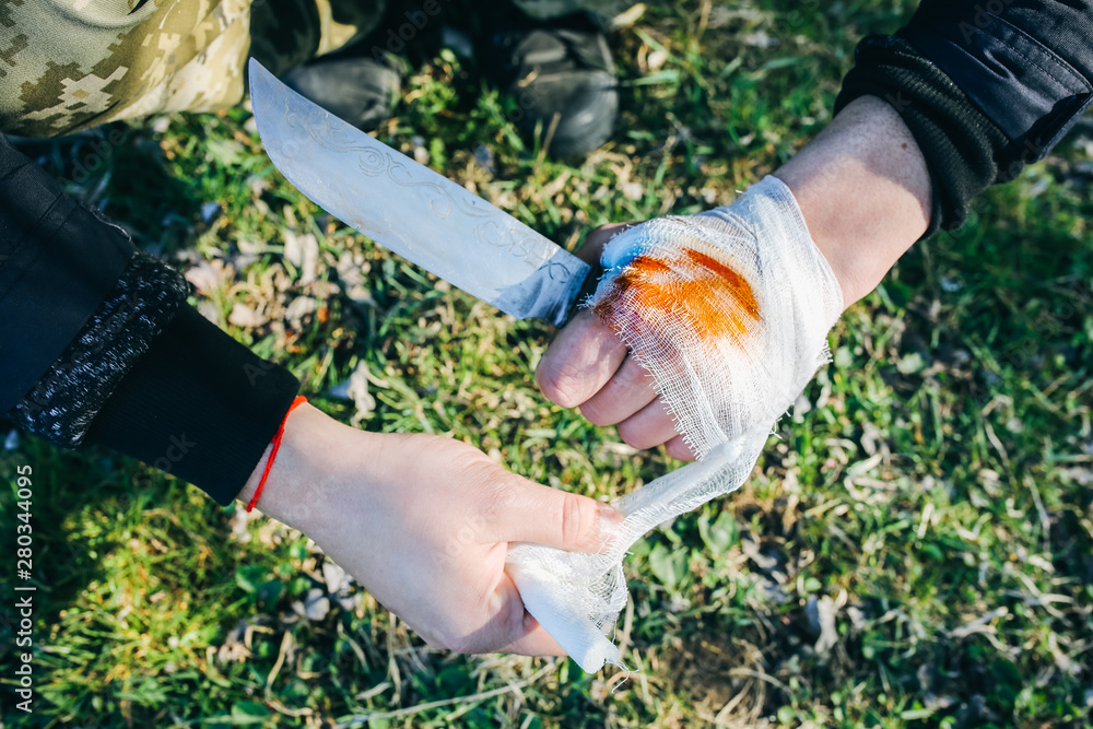 Man is putting bandage on bleeding wound. Injured hand. Cut with a ...