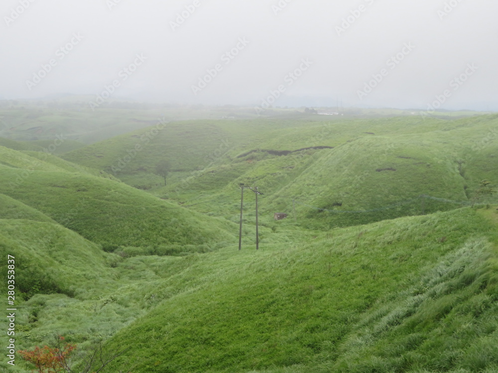Misty grass hills lying across Aso Caldera viewed from Daikanbo Stock ...
