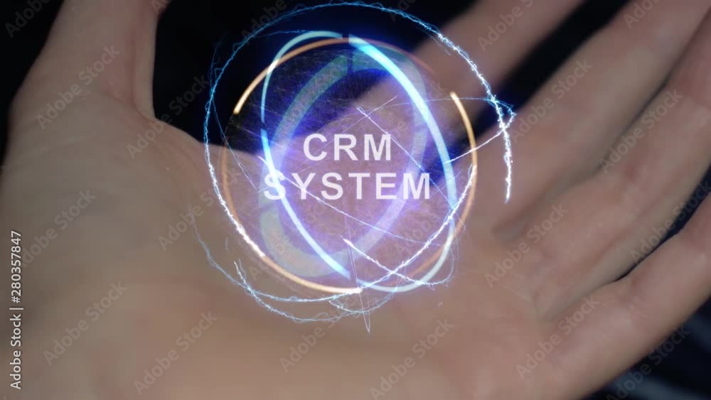 CRM system text in a round conceptual hologram on a female hand. Close ...