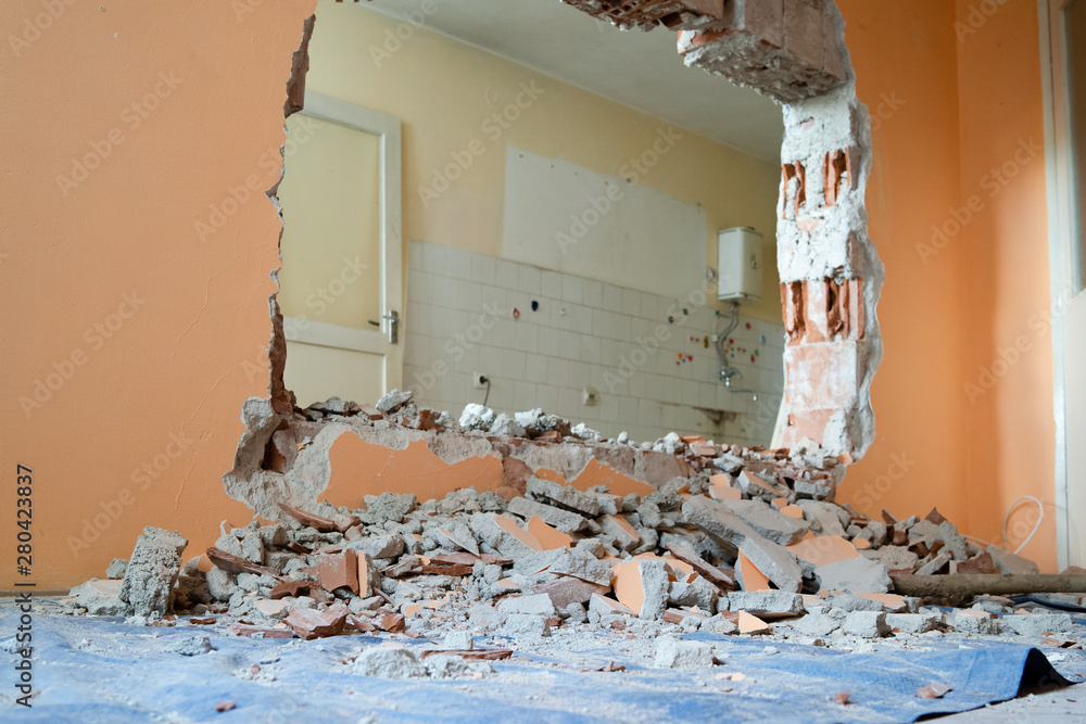 Wall smashed into debris room in apartment ready for renovation with ...