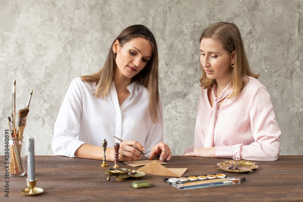 Learning calligraphy in art workshop. Teacher and students. Art school ...