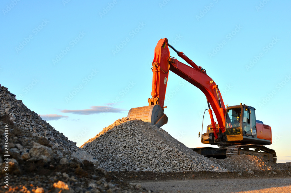 Large tracked excavator works in a gravel pit. Loading of stone and ...
