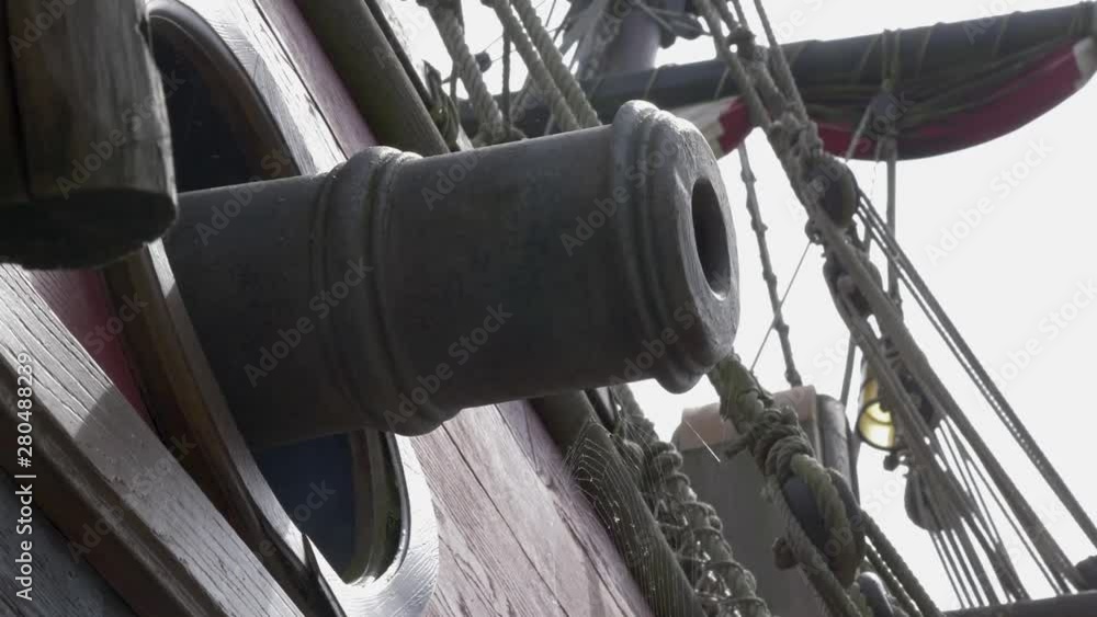 Bronze cannons, rope rigging and colourful sails on a naval sailing ...