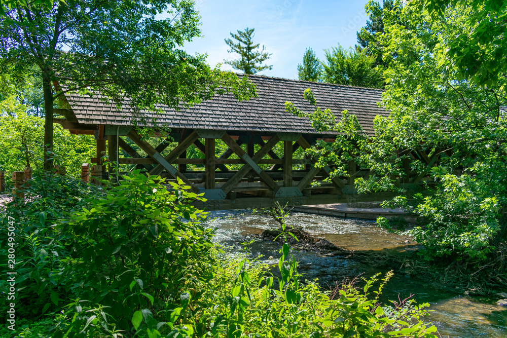 Covered Bridge with Trees along the Naperville Riverwalk over the ...