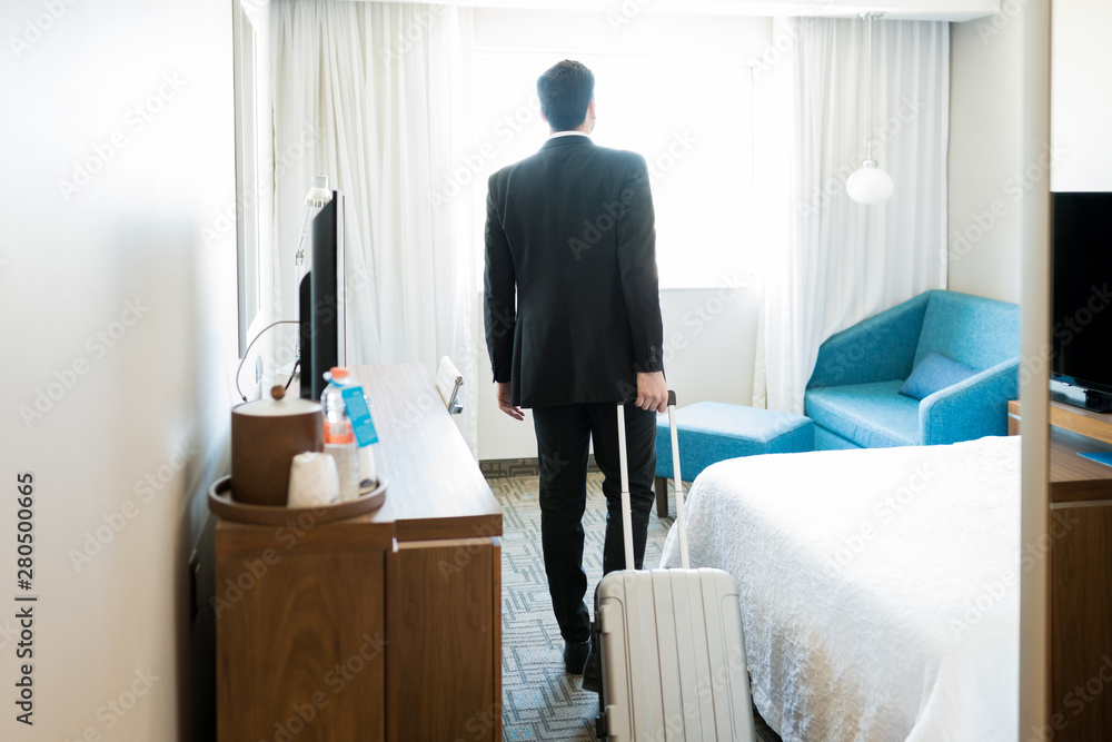 Manager Entering Hotel Room With Luggage Stock Photo | Adobe Stock
