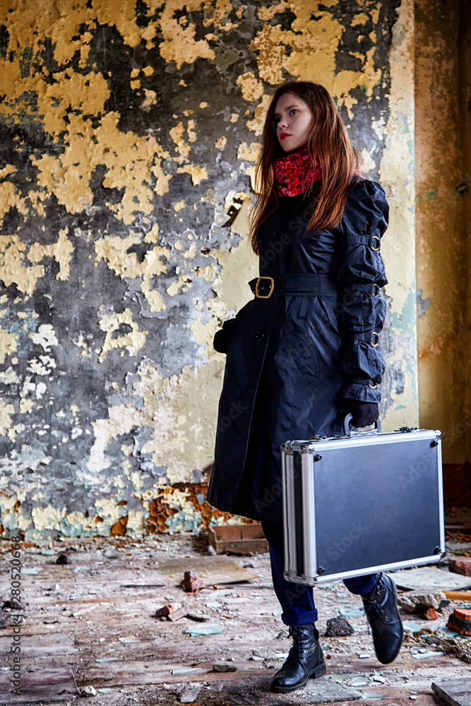Girl in a black cloak with a diplomat in a ruined room. A spy in a ...